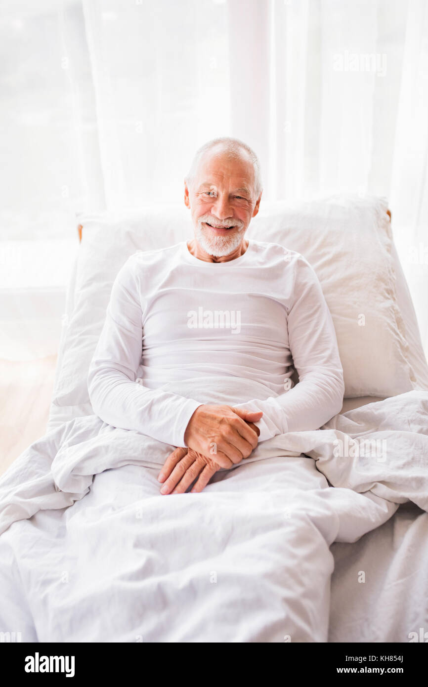 Elderly man lying in bed hi-res stock photography and images - Alamy