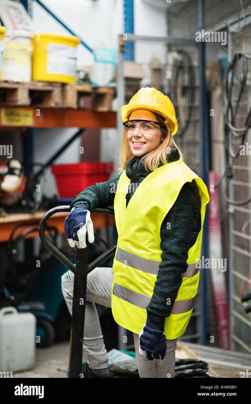 Young female worker in a warehouse Stock Photo - Alamy