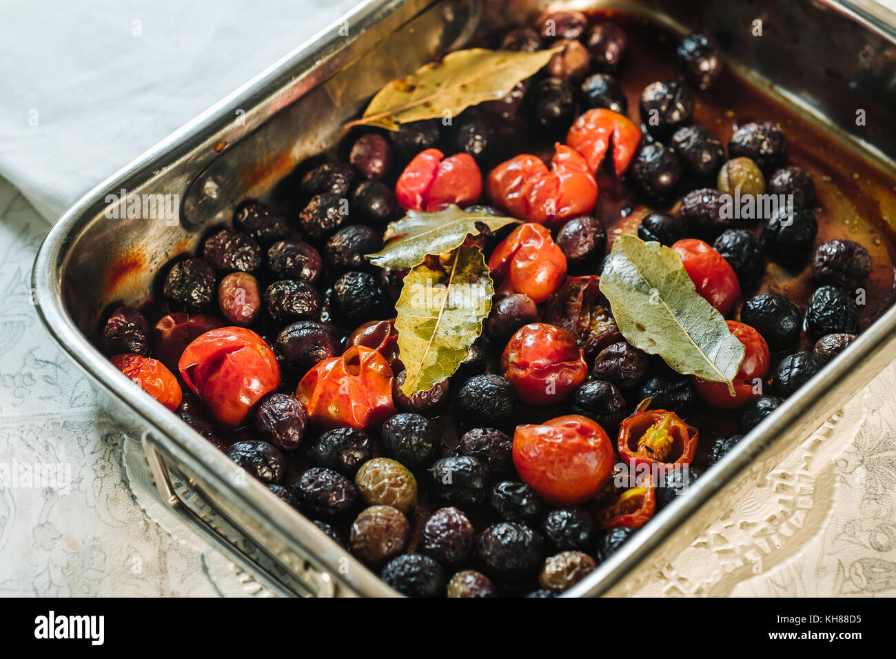 Delicious cooked black olives with cherry tomatoes Stock Photo - Alamy