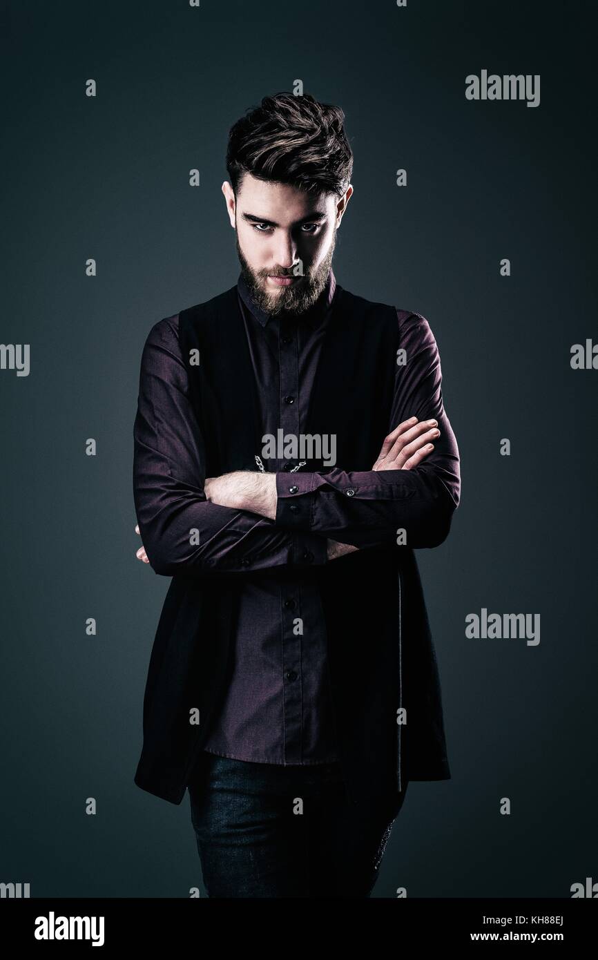 Young Hipster shirt and jacket, arms folded, looking at the camera ...