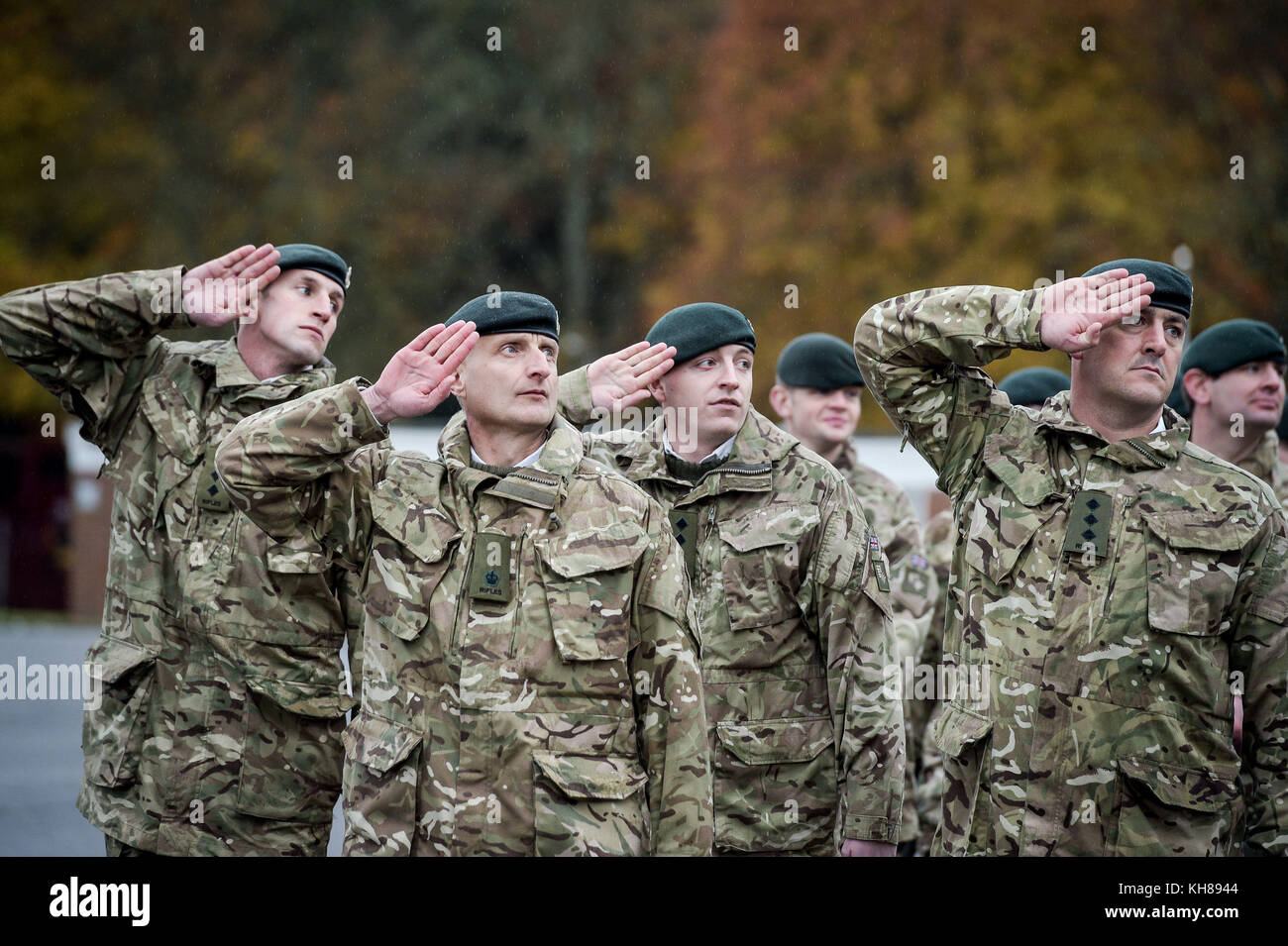 Soldiers salute during a homecoming parade at Bulford Barracks, where ...