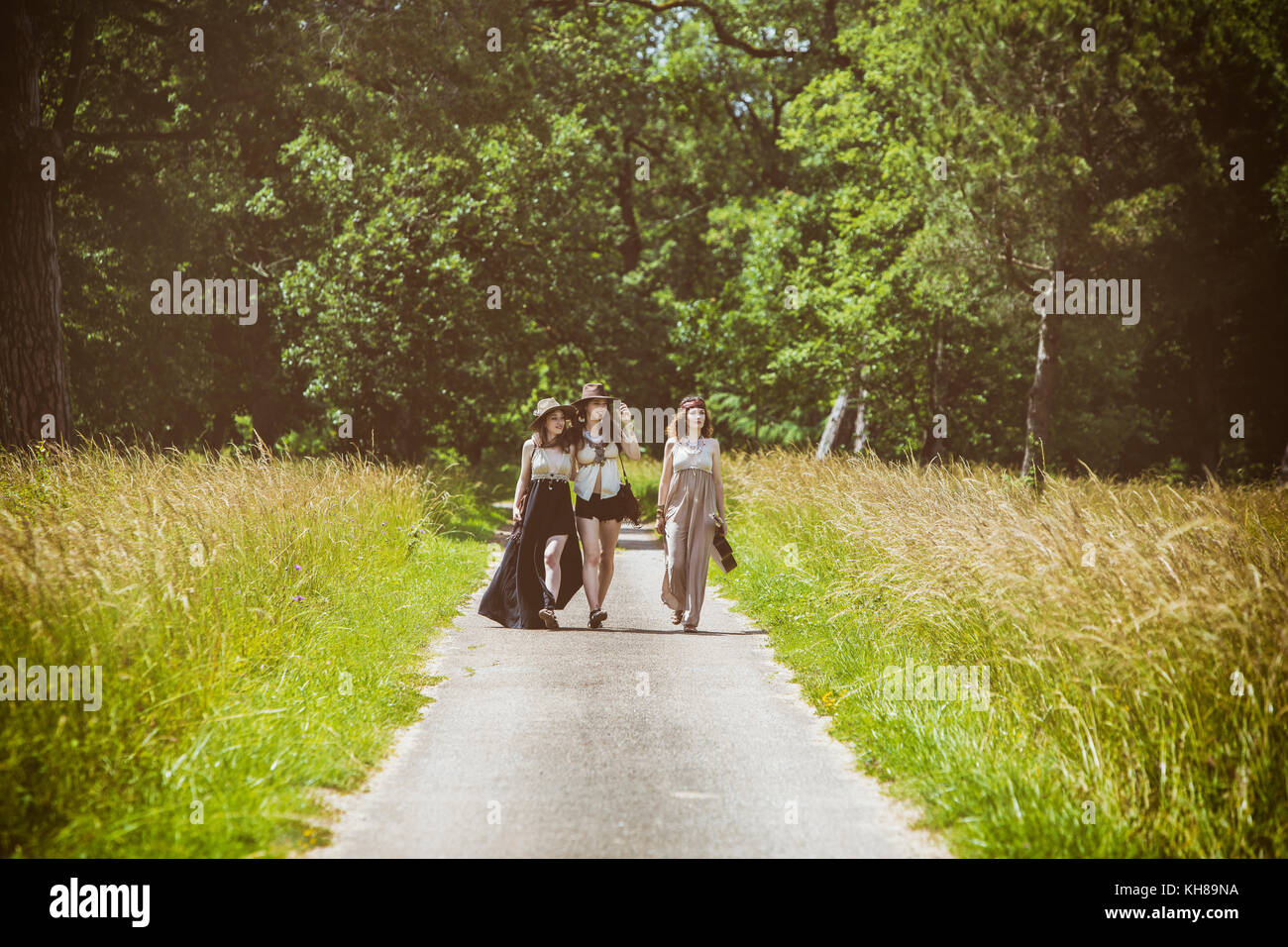Three young Hipster face, walking on the country road Stock Photo - Alamy