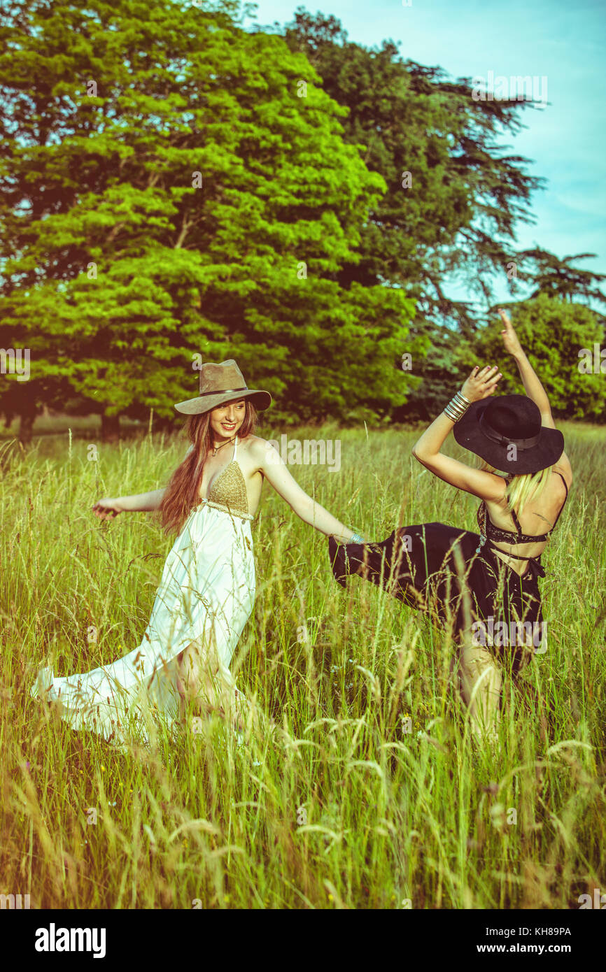 Portrait of two girls dancing in a field Stock Photo - Alamy
