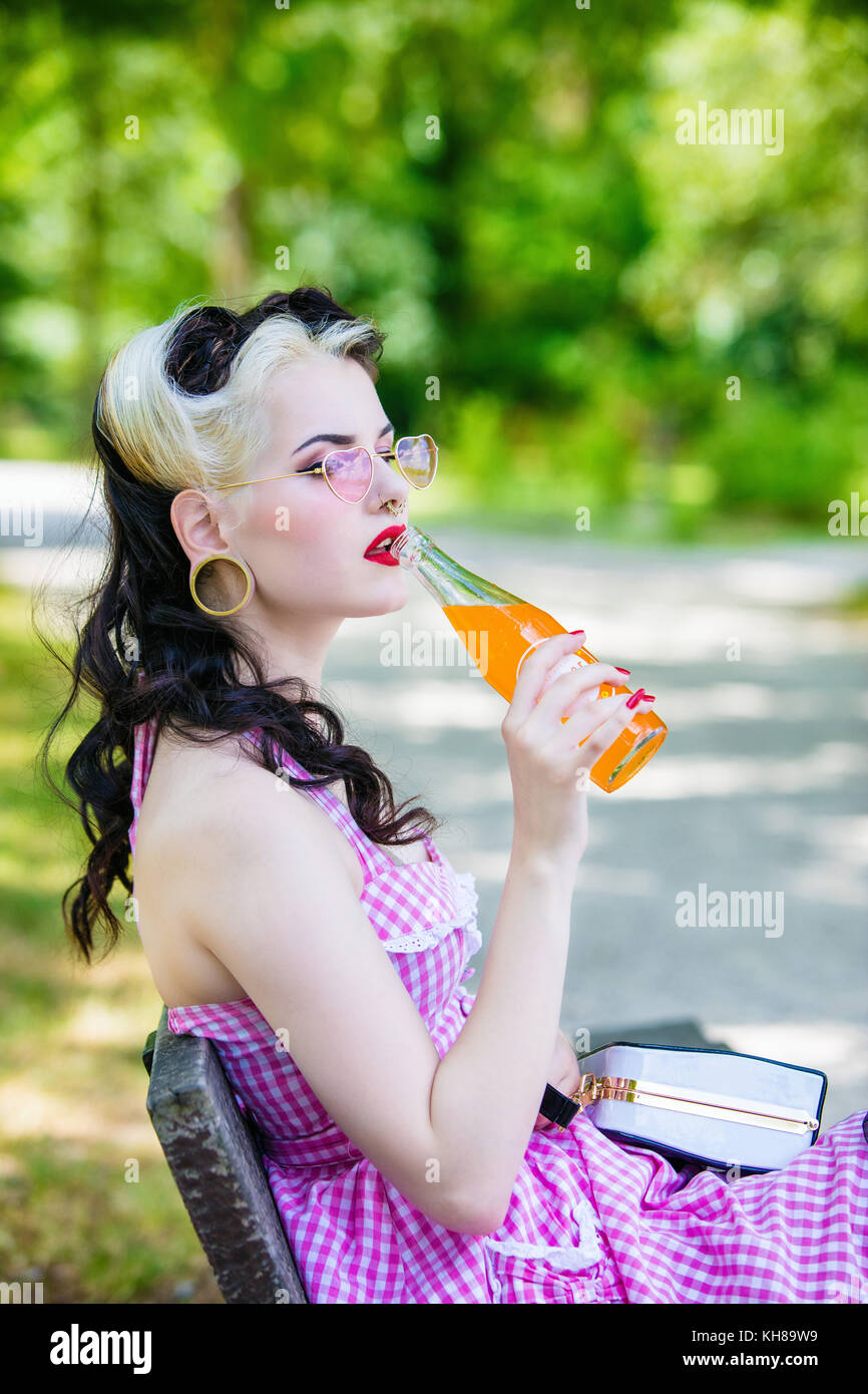 Portrait of a young Pin Up profile drinking a soda Stock Photo - Alamy