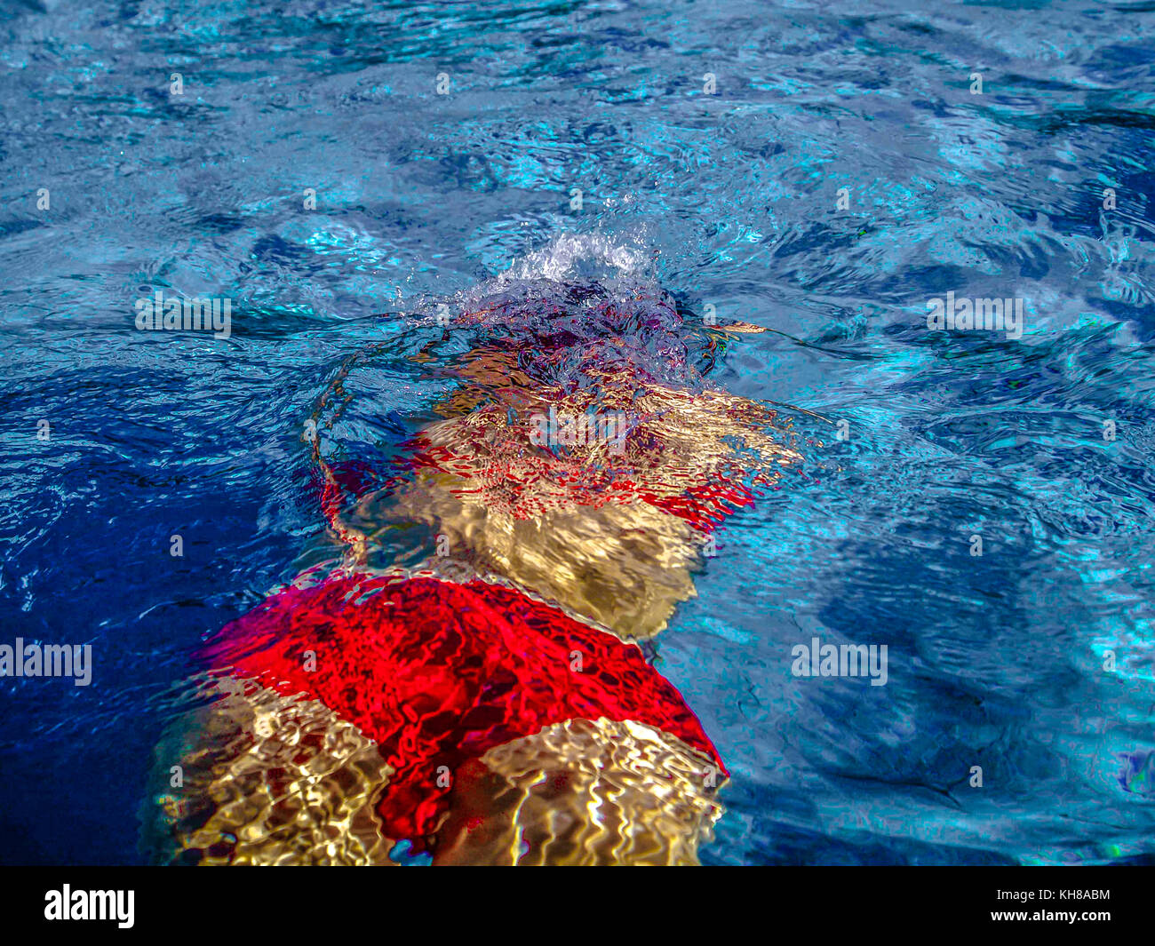 Women in red diving suit in a blue water pool Stock Photo - Alamy