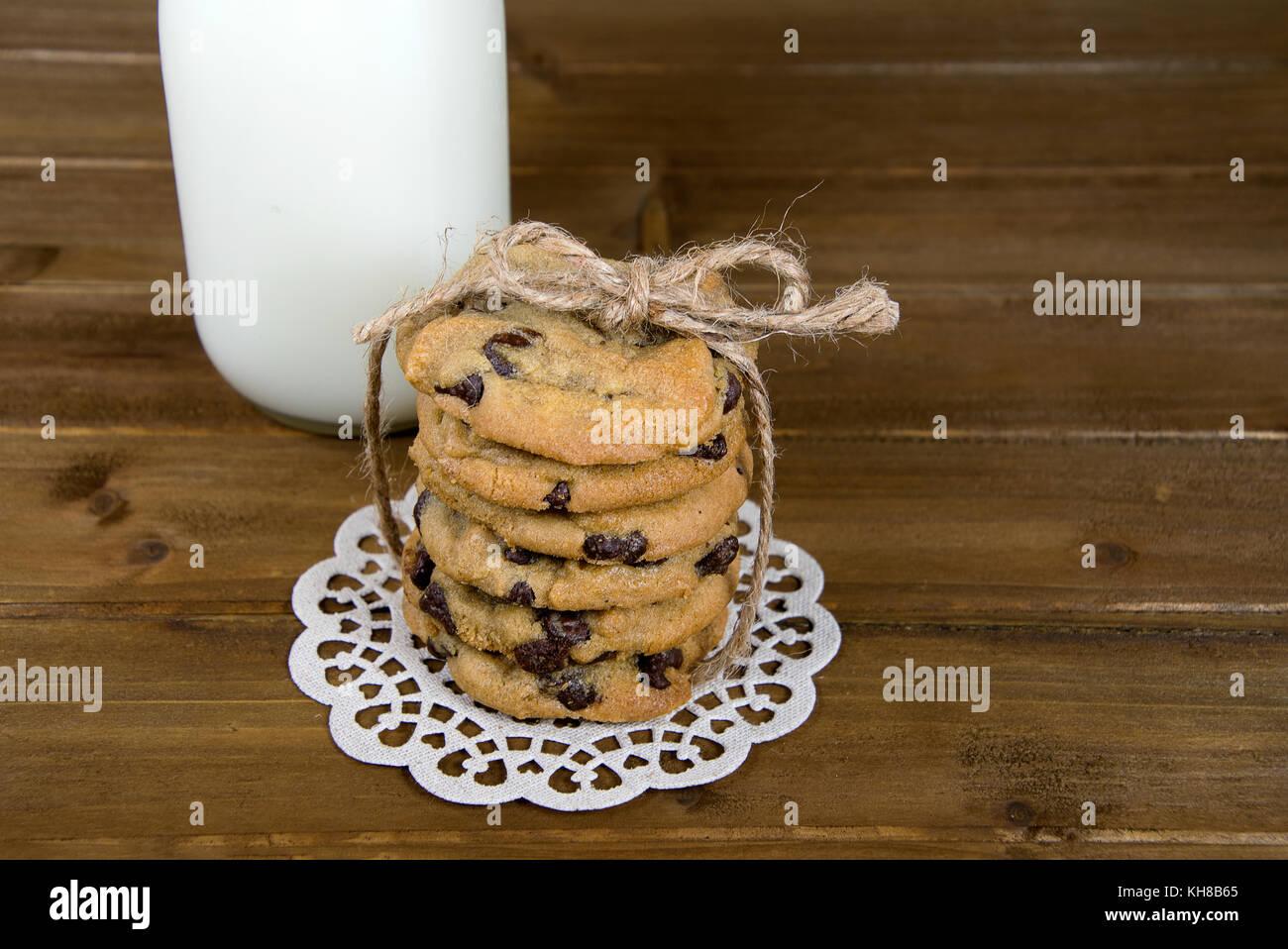 stack of chocolate chip cookies on lace doily with string bow and ...