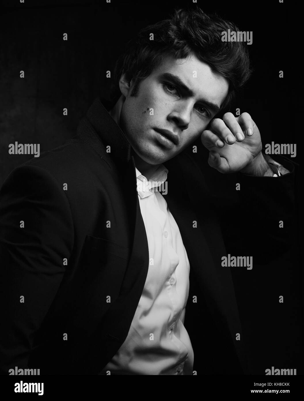 Confident thinking brutal man with strained look posing in blue fashion ...