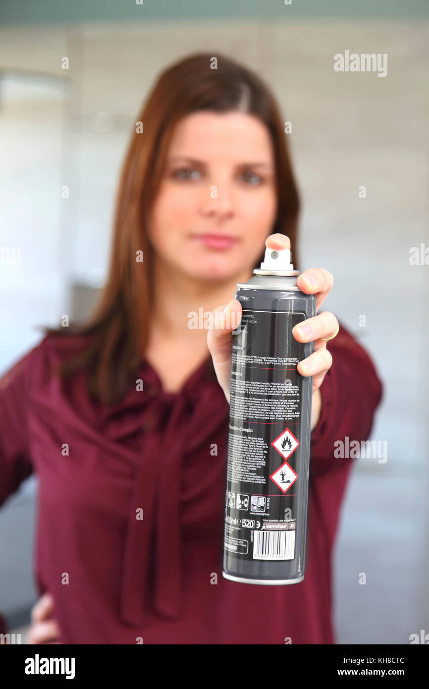 Young woman at home using air spray Stock Photo - Alamy