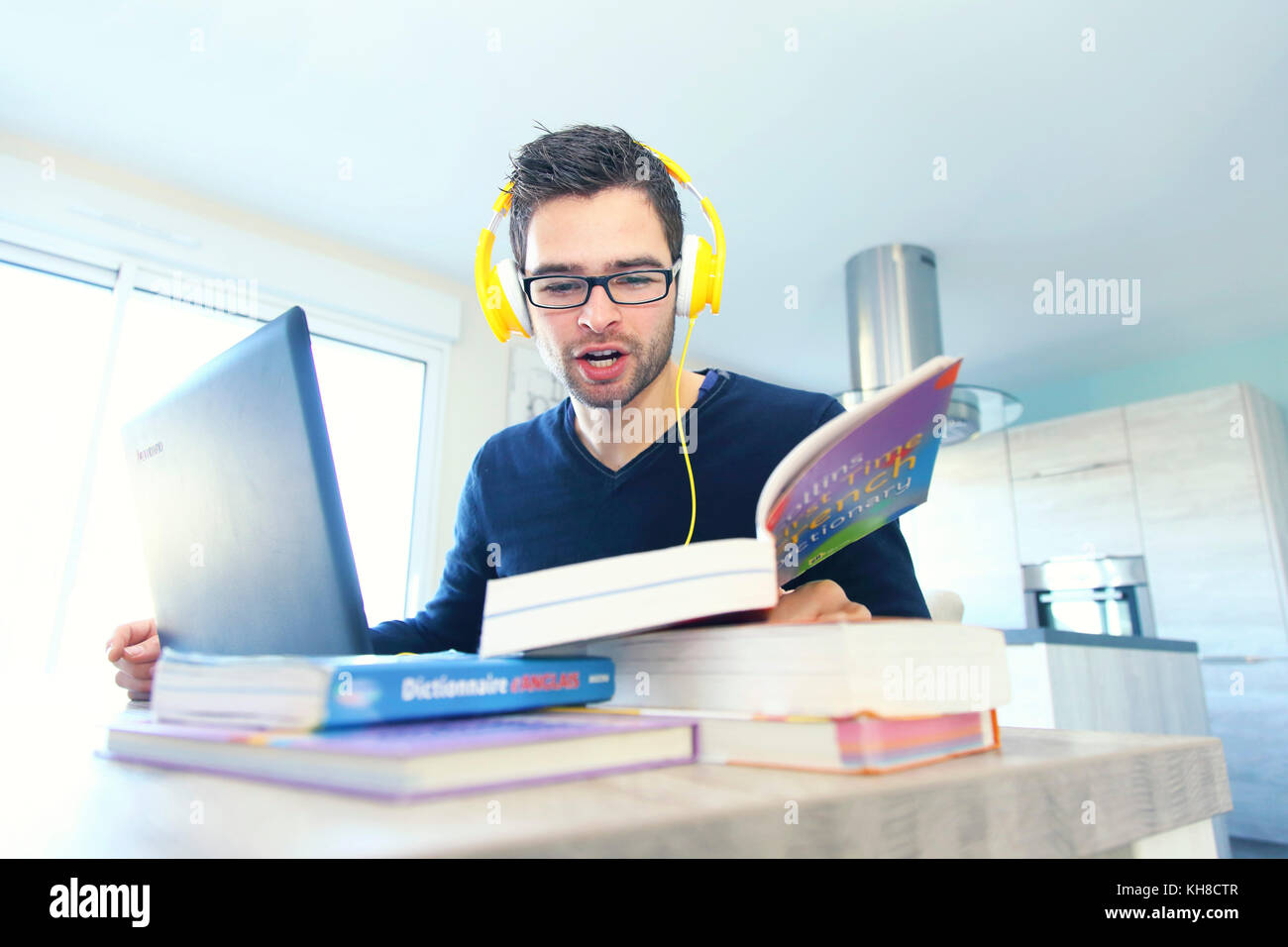Young man at home learning new language with computer Stock Photo - Alamy