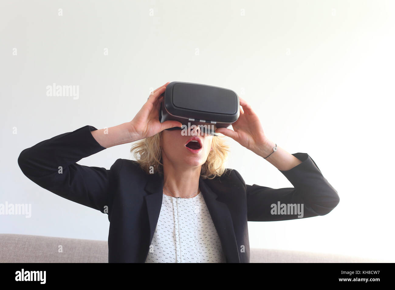 Young woman at home using virtual mask Stock Photo - Alamy