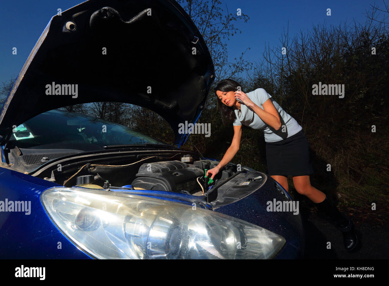 Woman and car. Problem Stock Photo - Alamy
