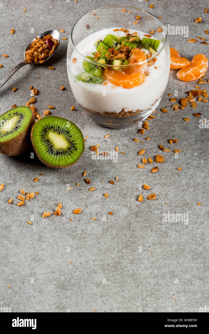 Healthy tangerine and kiwi yogurt granola dessert for breakfast, with ...