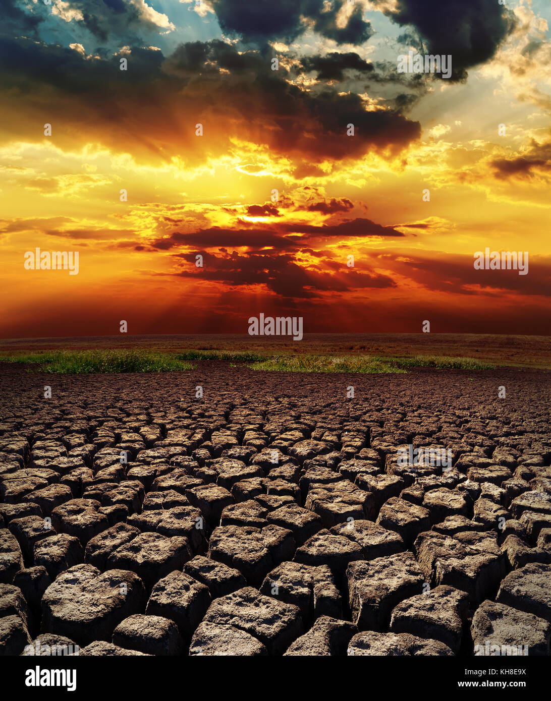 dramatic sunset over drought land Stock Photo - Alamy