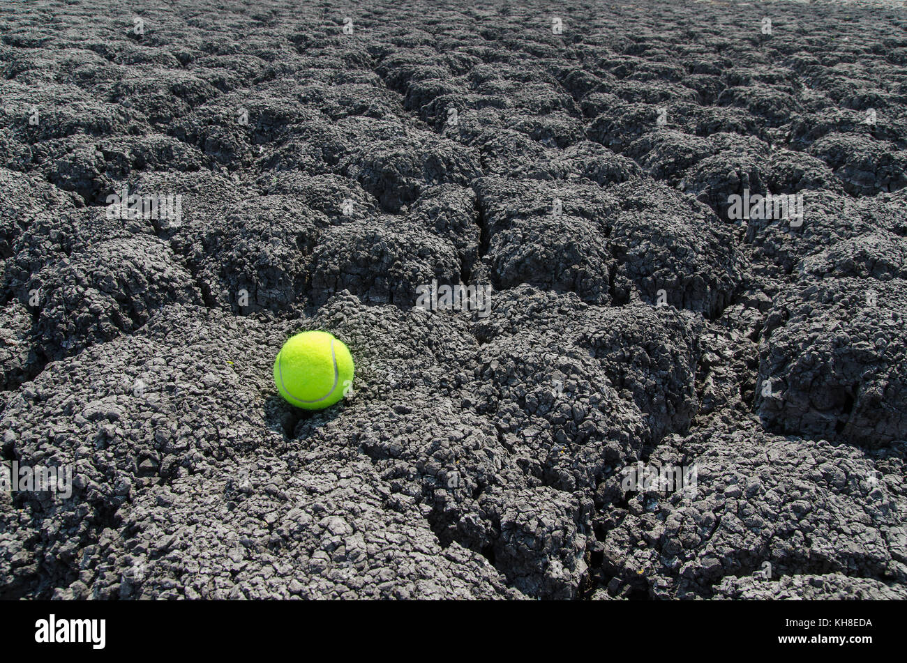 tennis ball on cracked land Stock Photo - Alamy