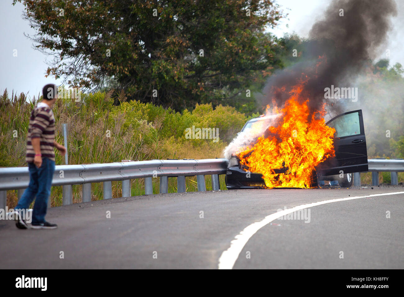 Car on fire with passengers on highway Stock Photo - Alamy