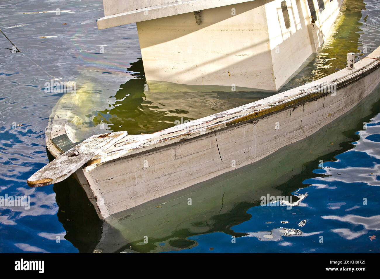 Small Sinking boat in water Stock Photo - Alamy
