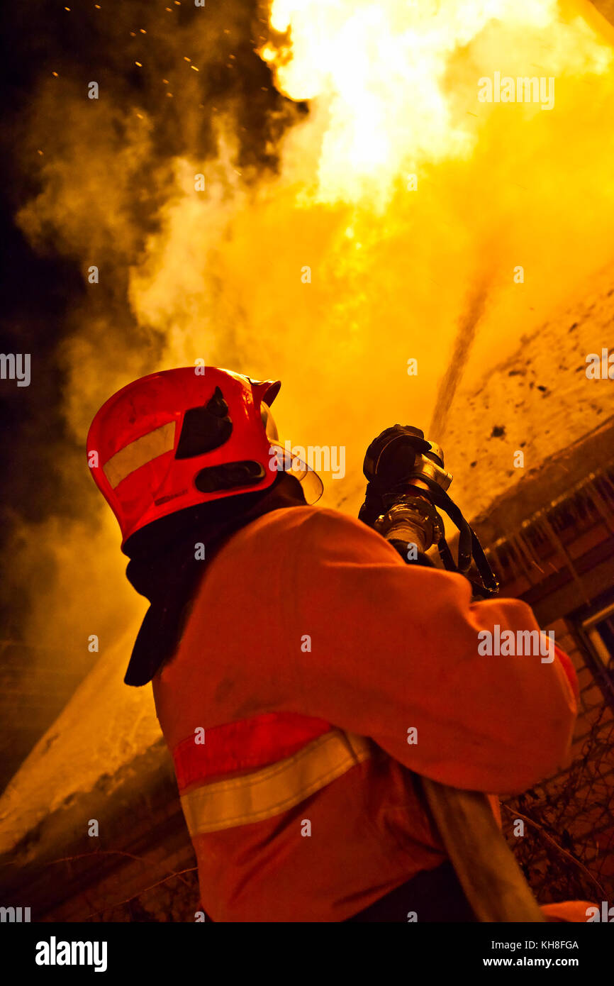 Fighting with the fire at night Stock Photo - Alamy