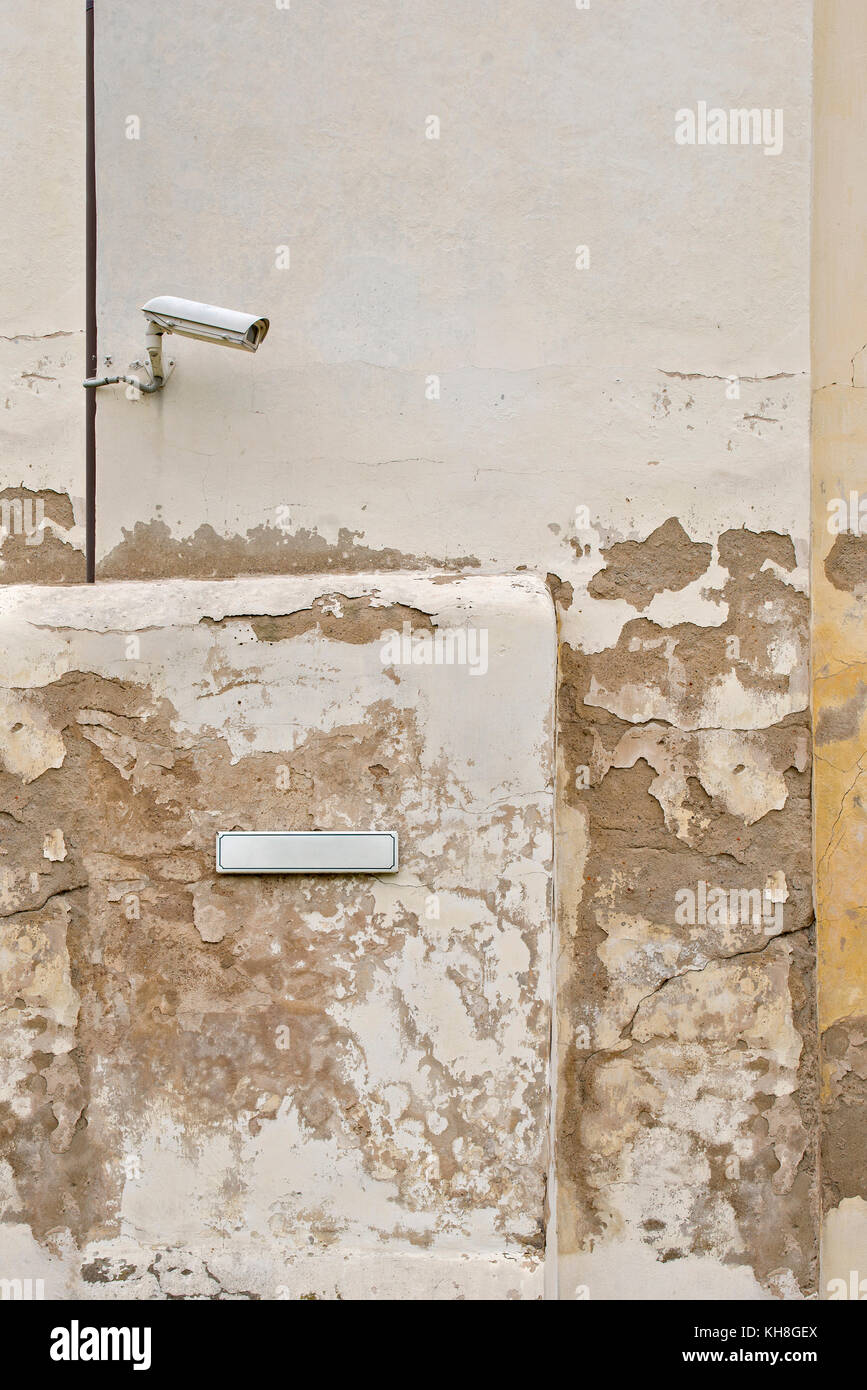 Security camera CCTV and metal plate for street name on the wall Stock ...