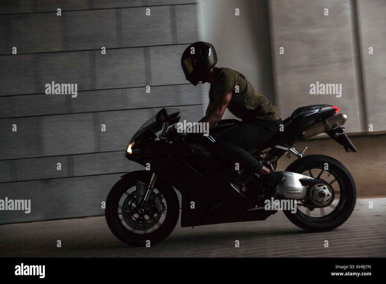 Portrait of a young afro american man in helmet riding motorcycle ...