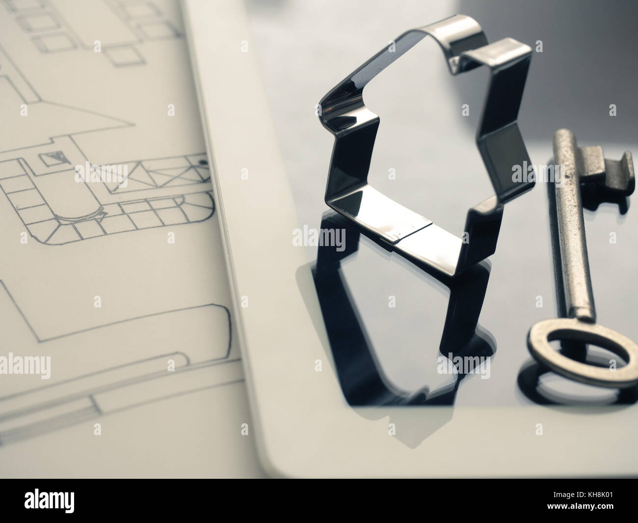 House shape with a key on a construction plan, new home or financial ...