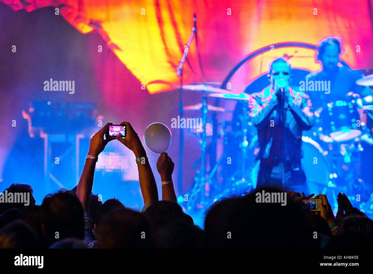 Filming at the concert with phone Stock Photo - Alamy