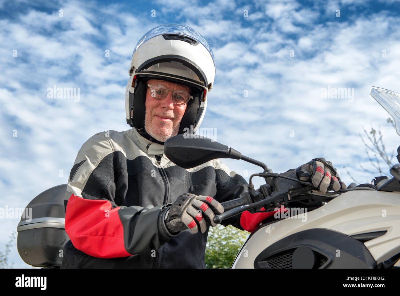 a portrait of a senior biker on his motorcycle Stock Photo - Alamy