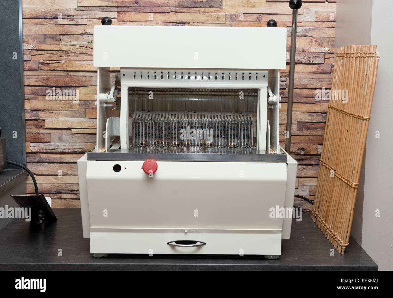 a close-up of automatic bread-slicer machine indoors Stock Photo - Alamy