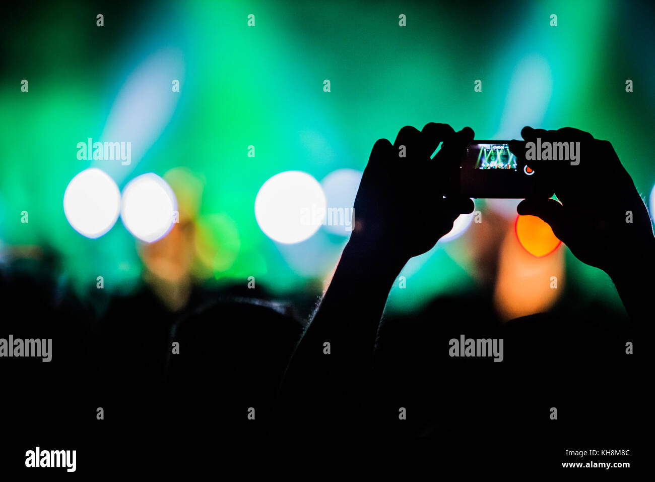 Taking pictures with phone on a show Stock Photo - Alamy