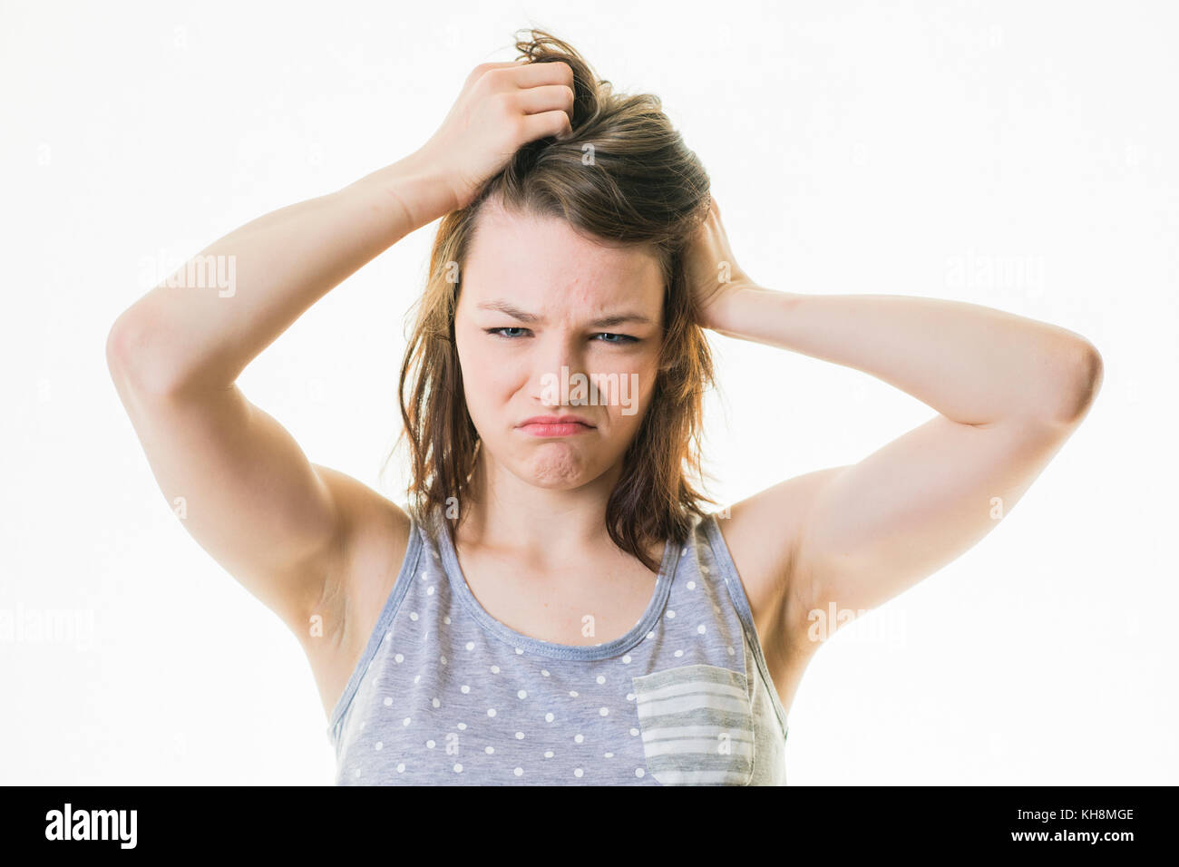 A young brown haired caucasian teenage girl wearing pyjams looking ...
