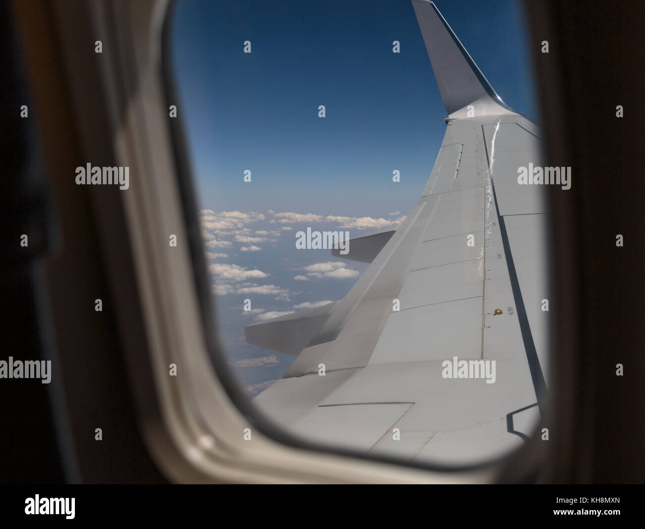 Looking Outside a Window of an Aircraft Cabin: White Airplane Wing and ...