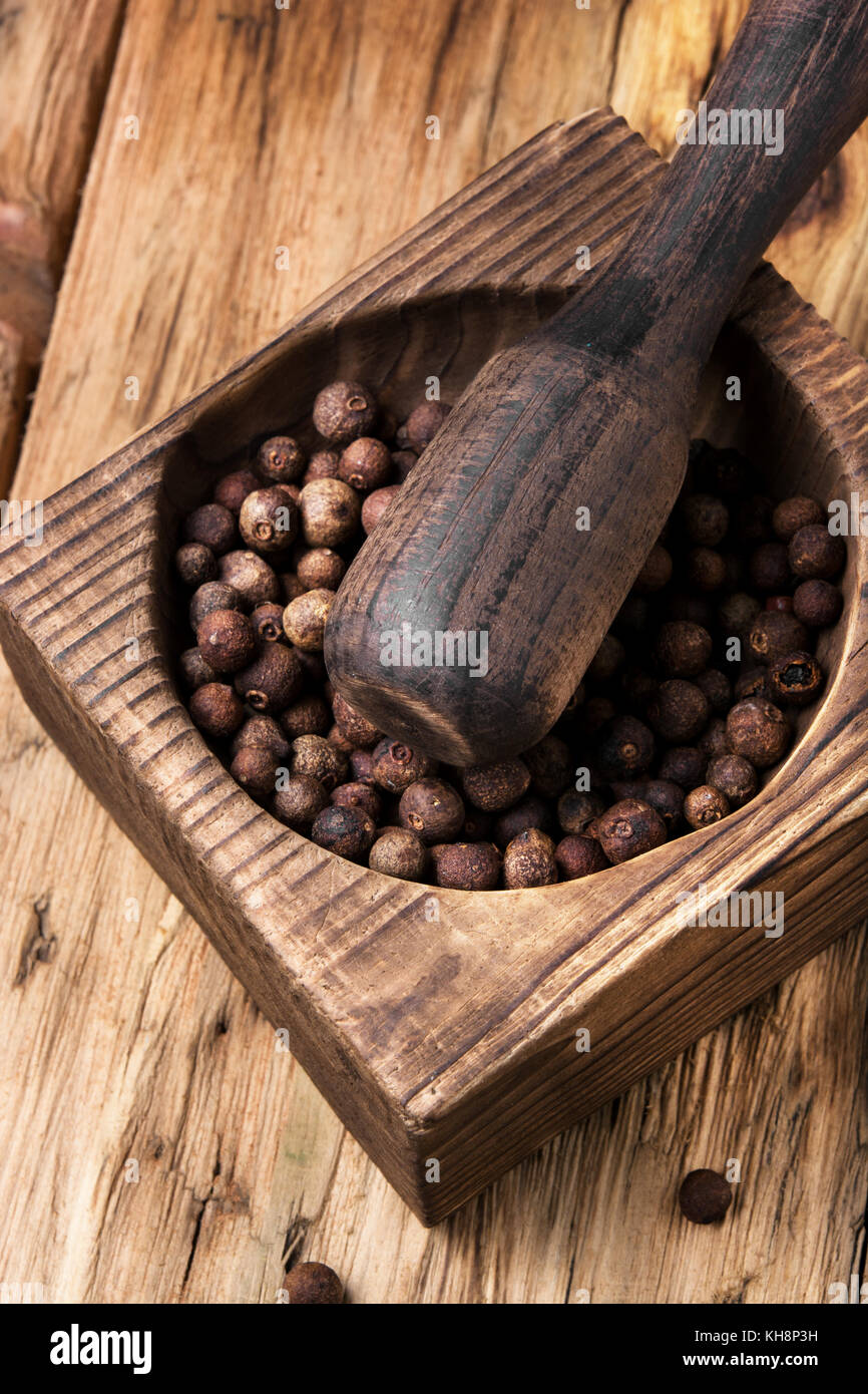 Black fragrant pepper peas in a stylish wooden mortar Stock Photo - Alamy