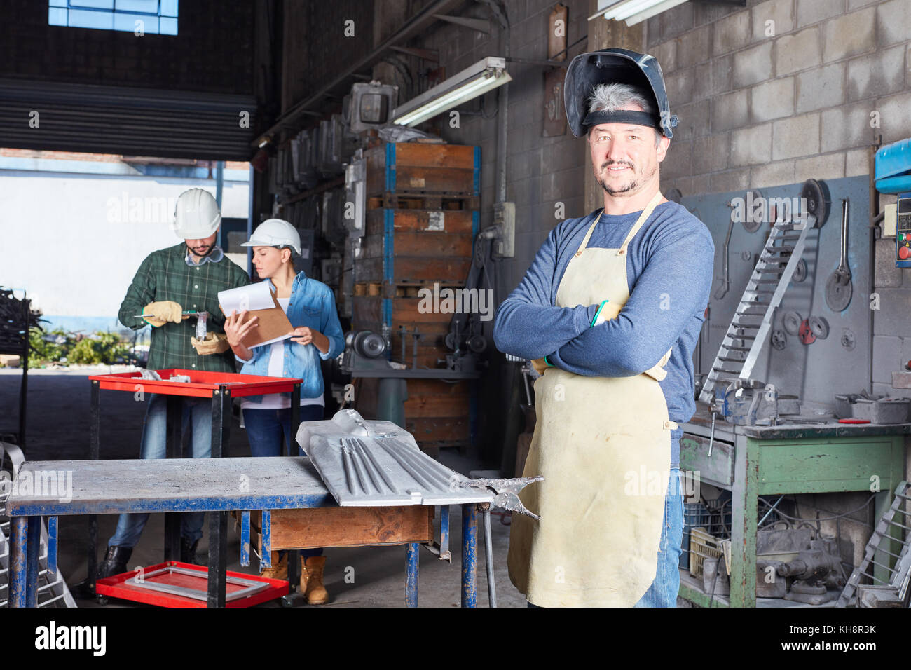 Man as worker and metalworker with experience in metallurgy workshop ...