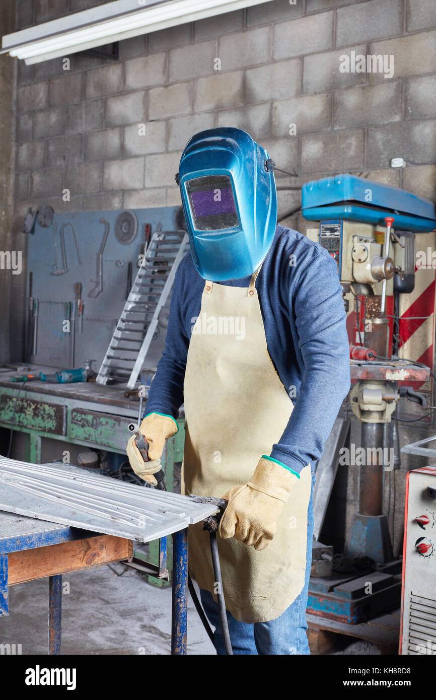 Welder worker with labor protection metalworking in metallurgy workshop ...