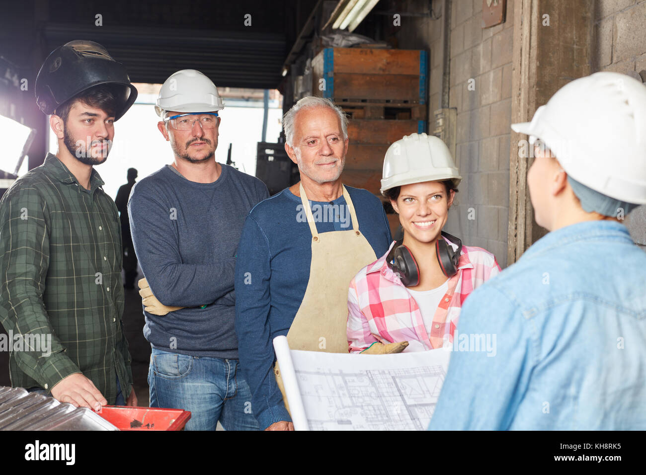 Team of blue collar workers in meeting planning operation Stock Photo ...
