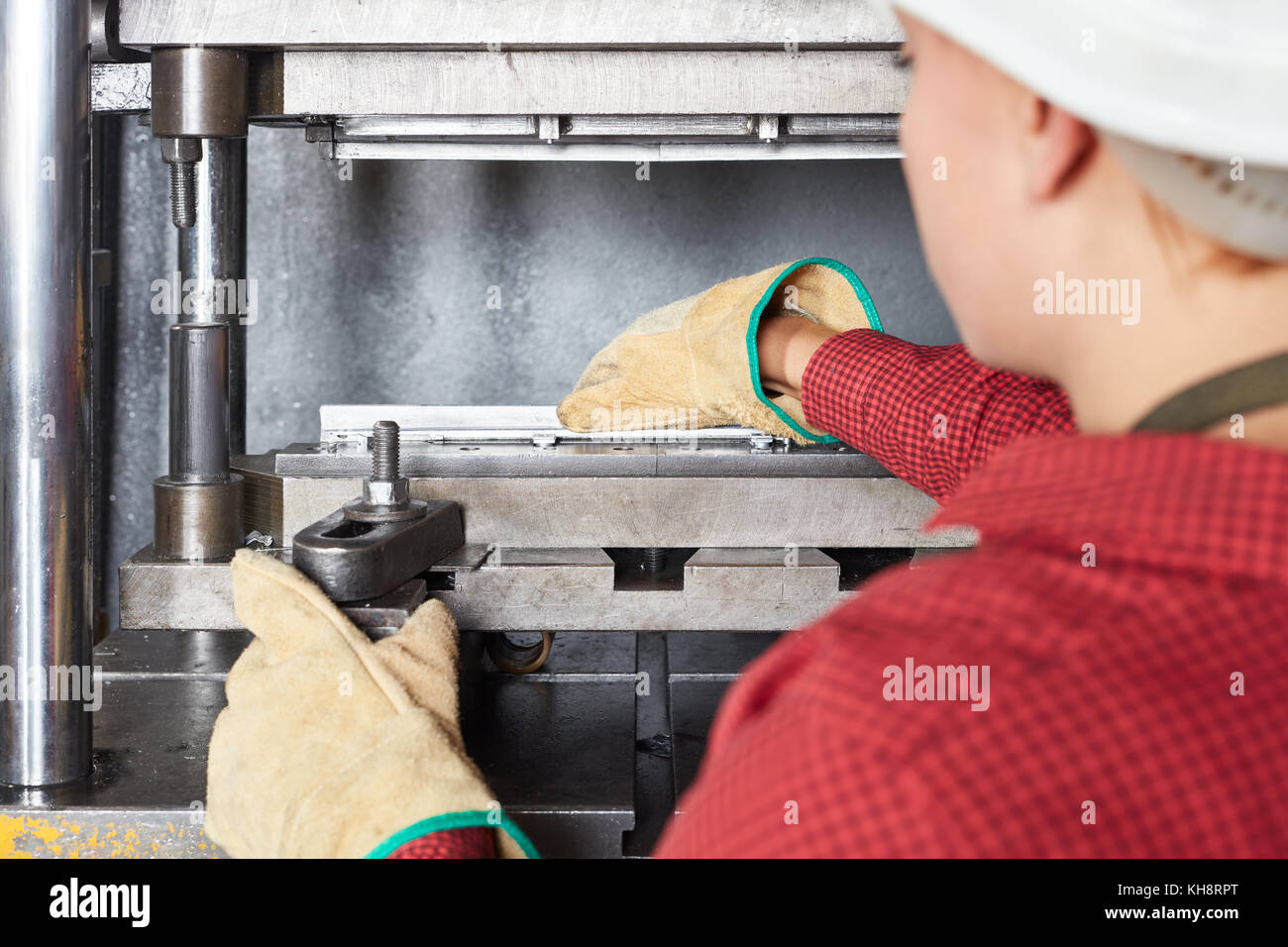 Metalworking with punch press in metallurgy workshop Stock Photo - Alamy