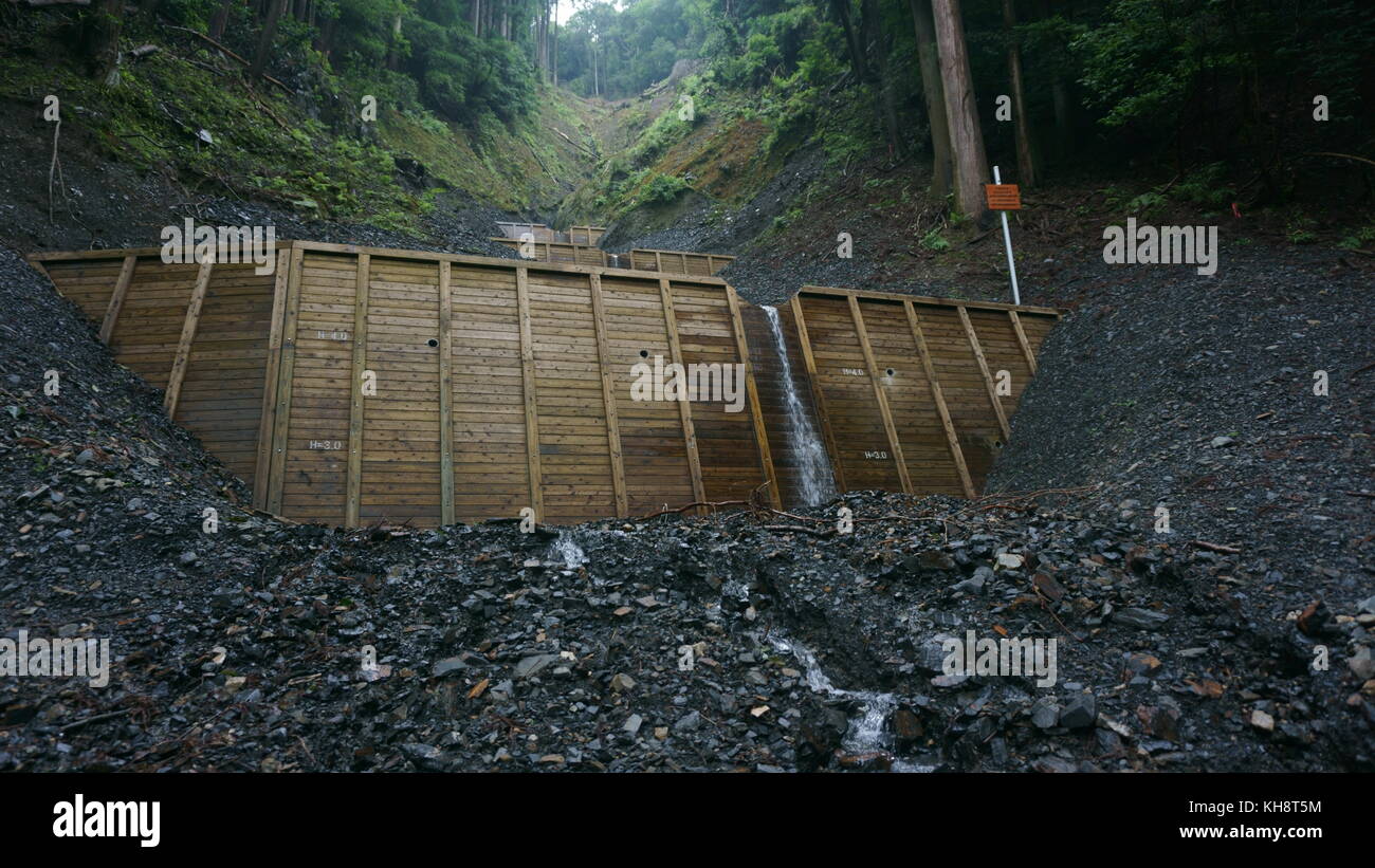 Water flowing down a hill through small dams Stock Photo - Alamy