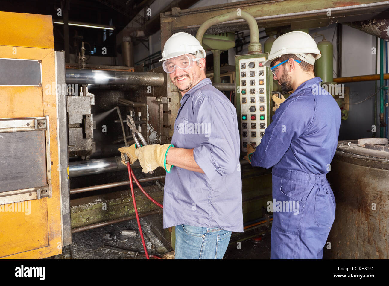 Workers controlling control box in metallurgy factory Stock Photo - Alamy