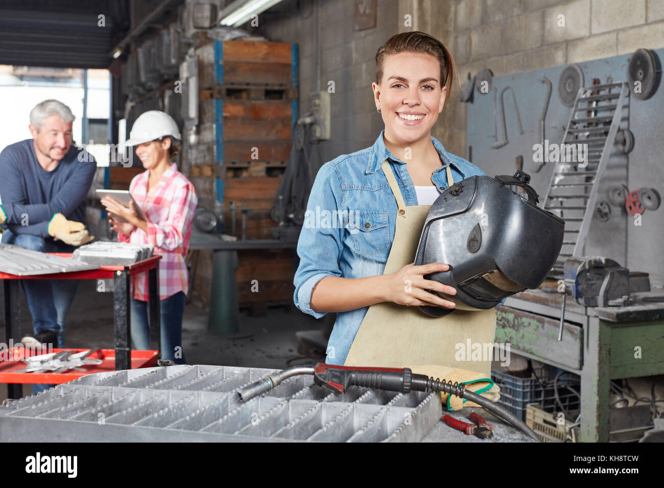 Young woman as metalworker apprentice in metallurgy workshop Stock ...