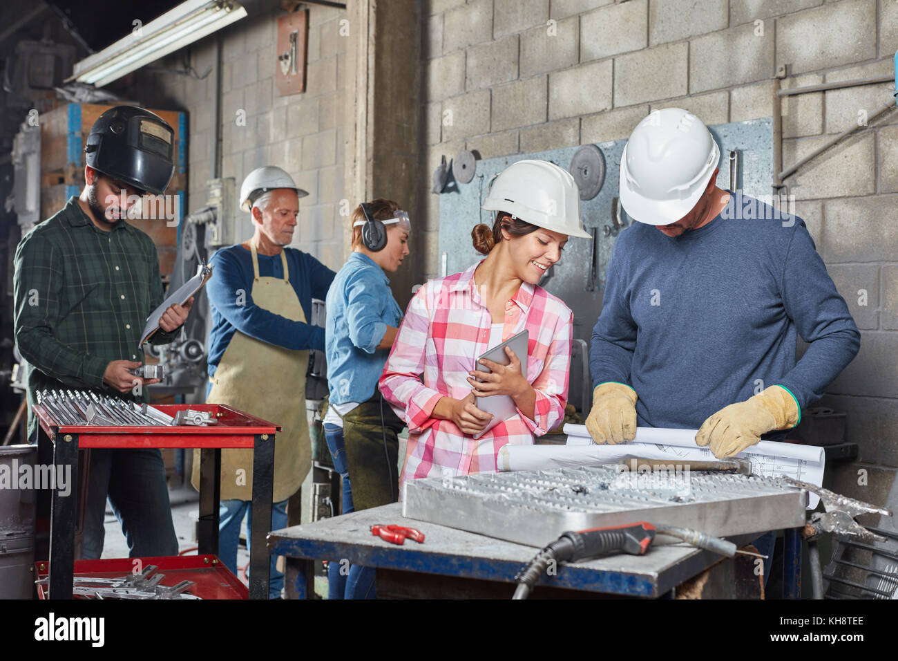 Group of workers in metallurgy workshop working in cooperation Stock ...