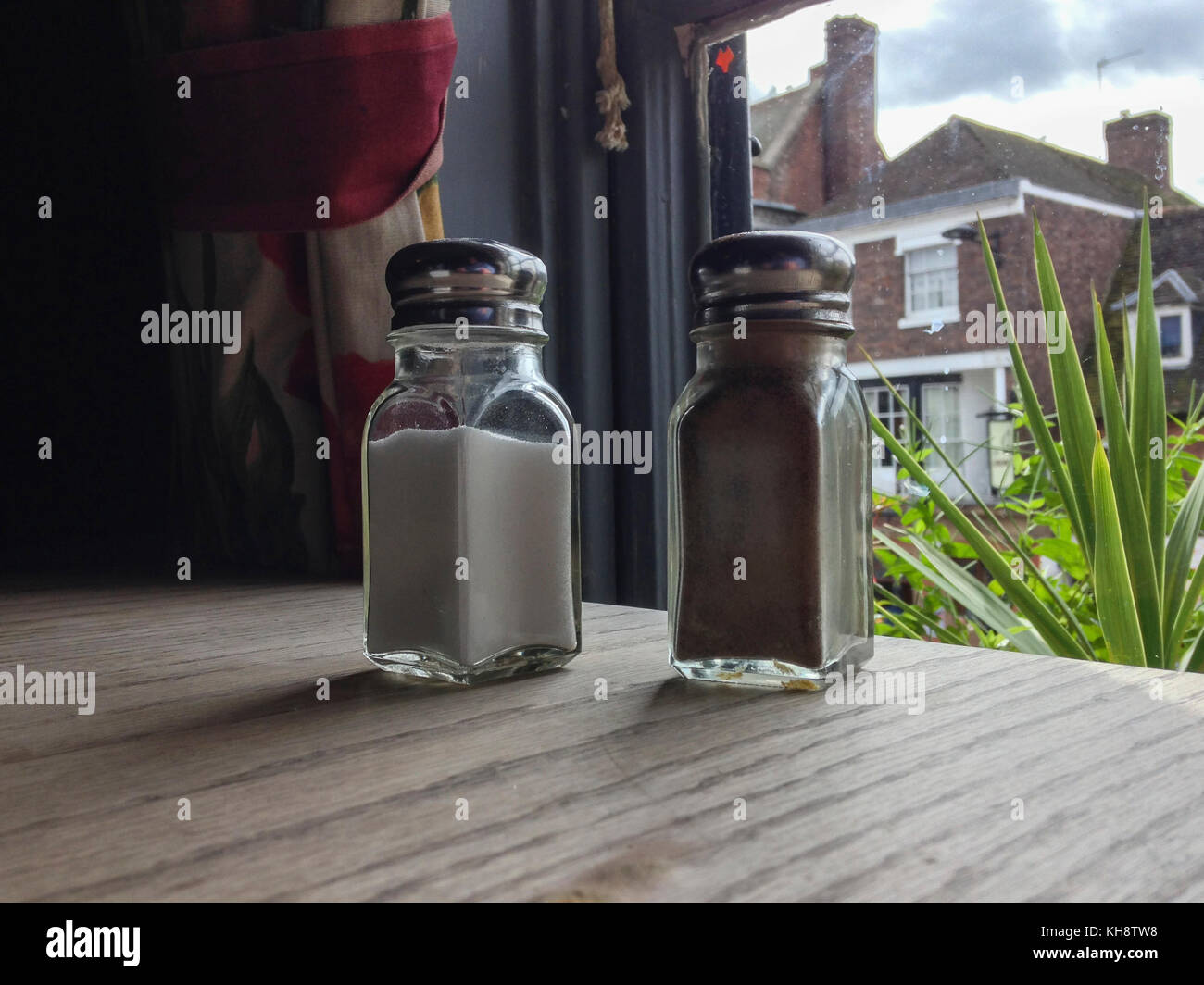 Glass slat and Pepper pot on cloth covered table Stock Photo - Alamy