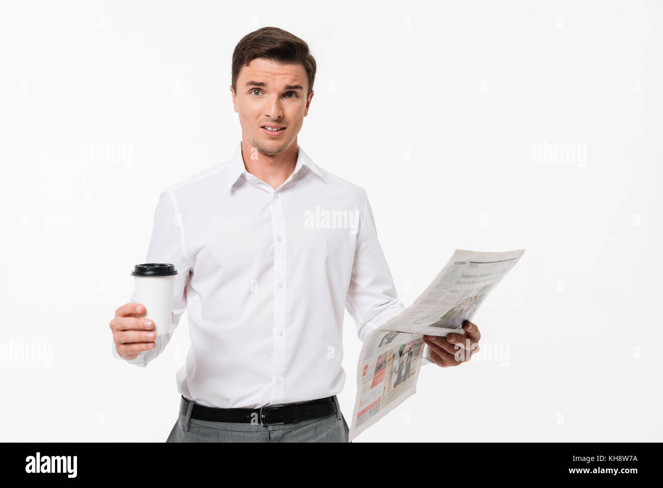 Portrait of a frustrated confused man in a white shirt holding ...