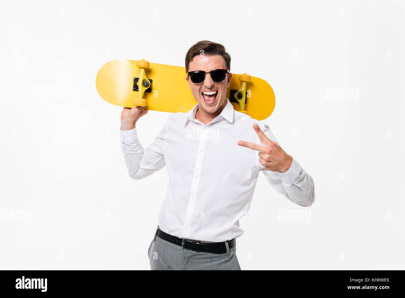 Portrait of a cheerful amused man in white shirt and sunglasses posing ...