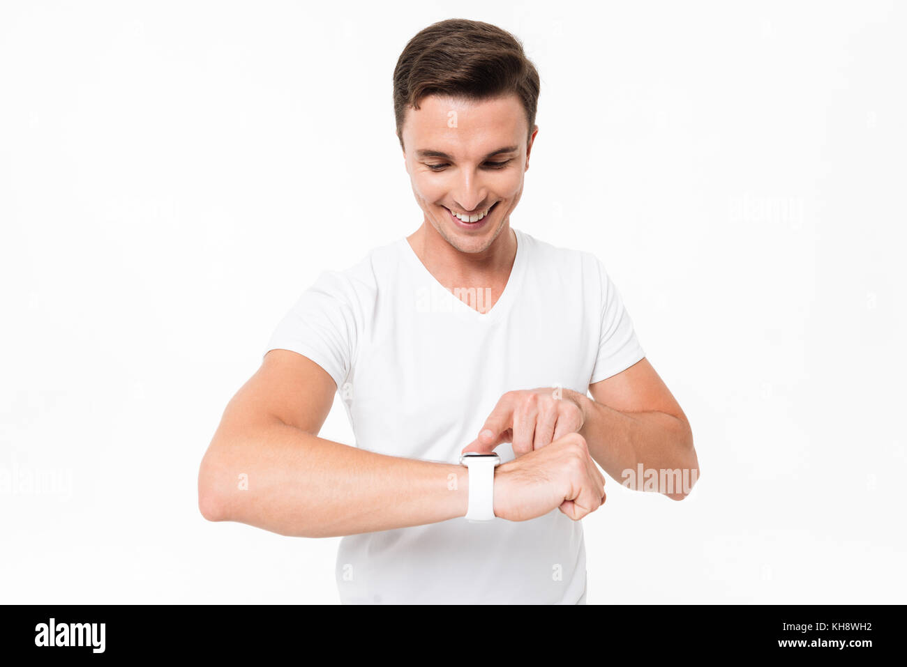 Portrait of a handsome modern man using smart watch while standing ...