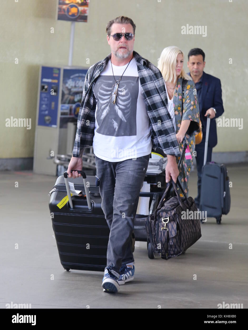 Tori Spelling arrives at LAX with her husband Dean McDermott and son ...