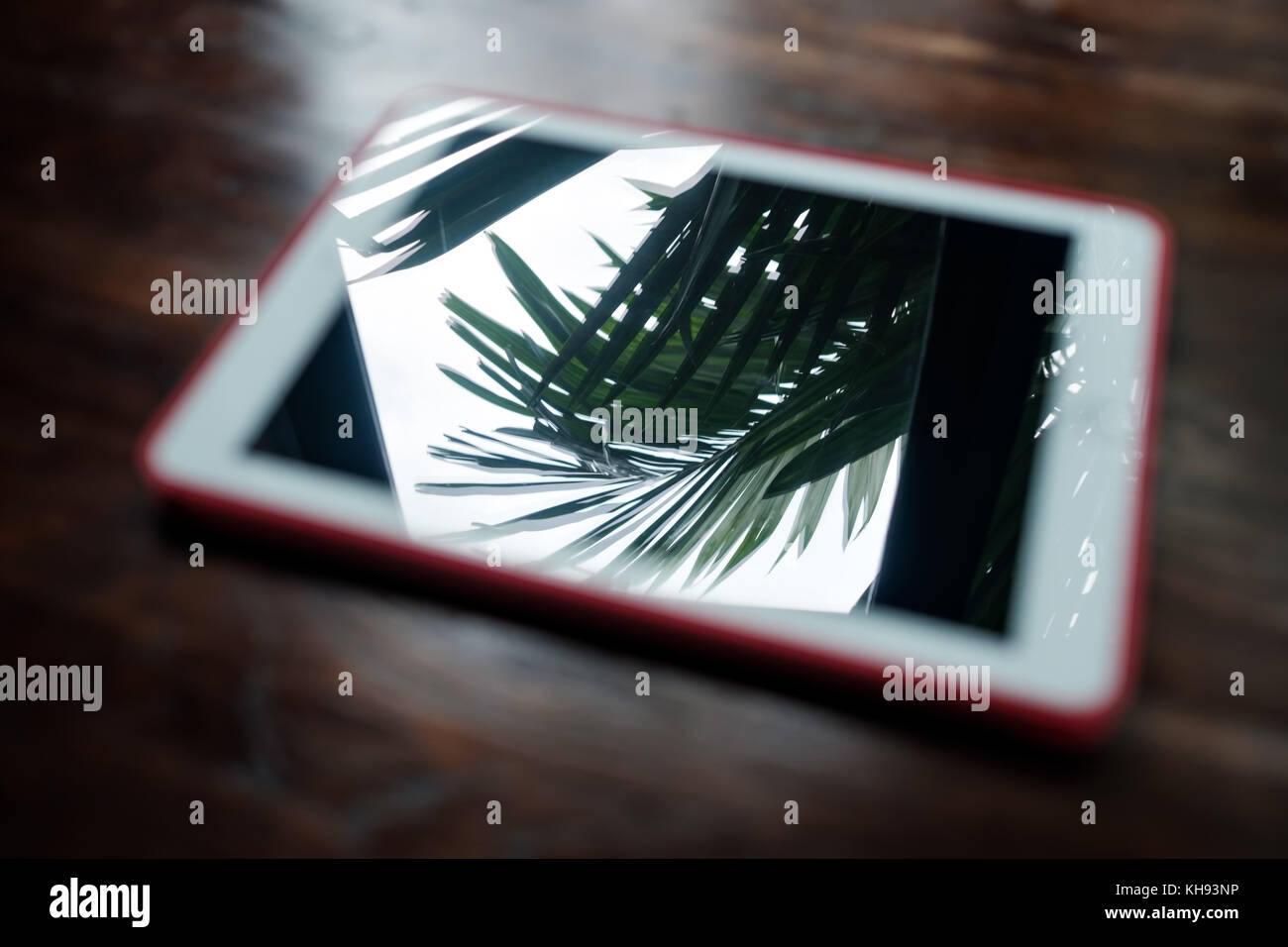 Tablet on old wood table background Stock Photo - Alamy
