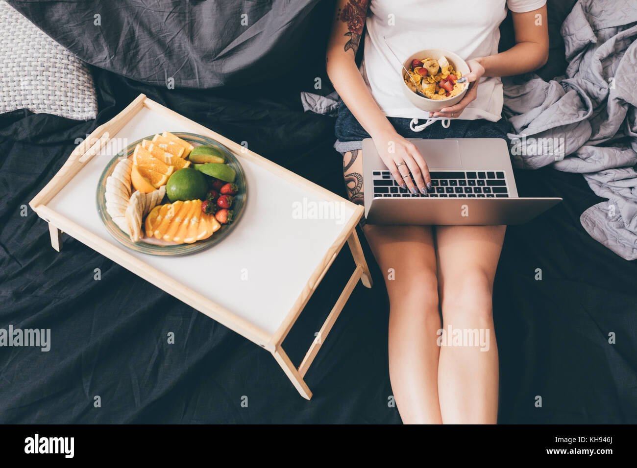 woman with laptop on bed Stock Photo - Alamy