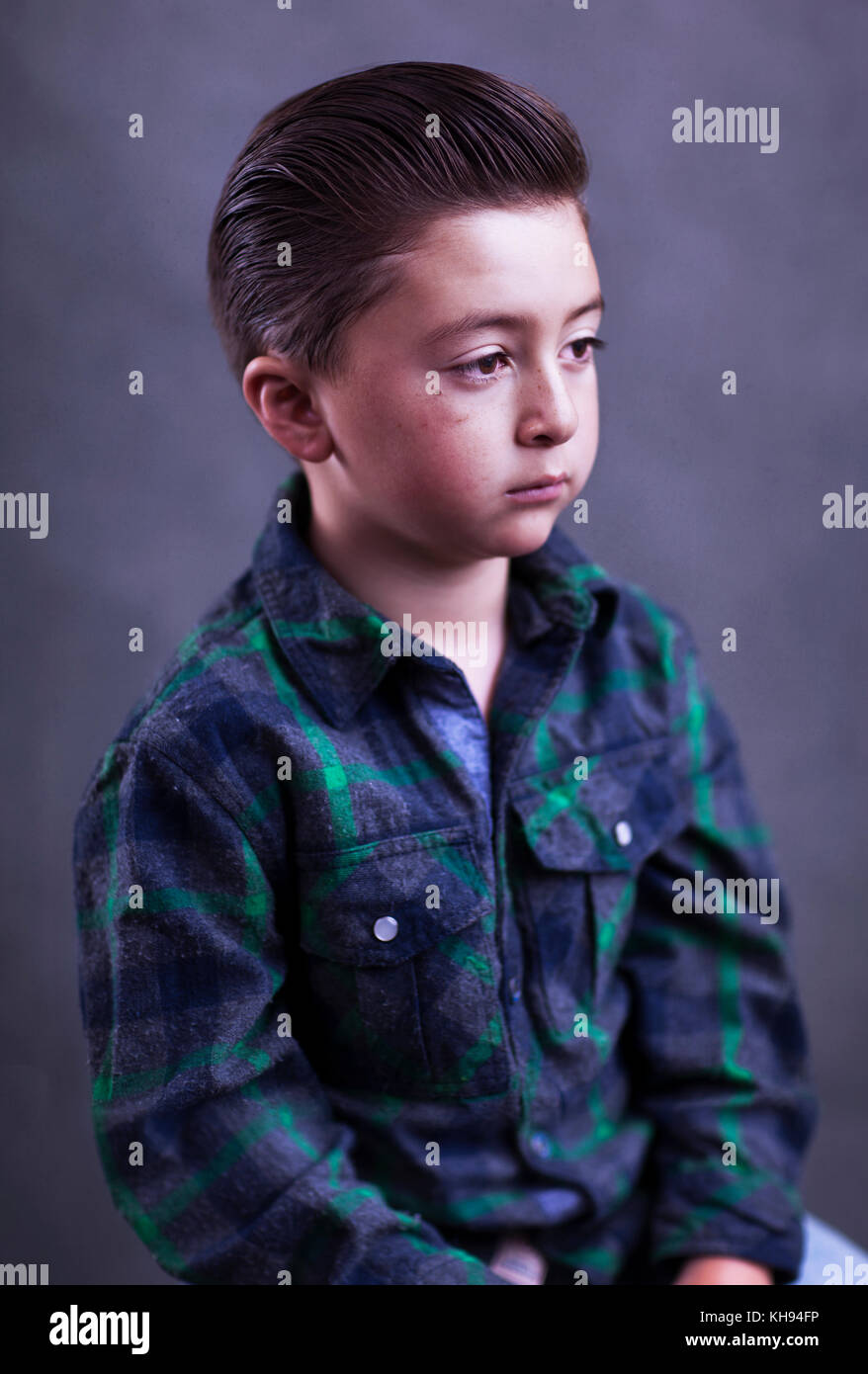 Handsome Mixed race Asian Caucasian boy with frown on his face wearing ...