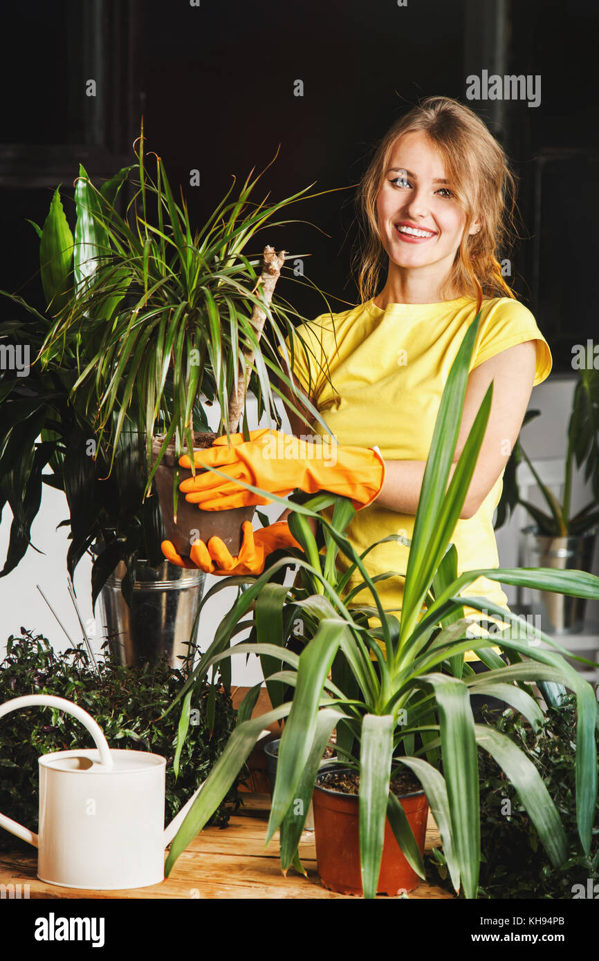 Cheerful girl taking care of green plants Stock Photo - Alamy