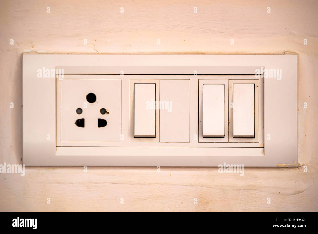 Beige rocker light switch with three buttons Stock Photo - Alamy