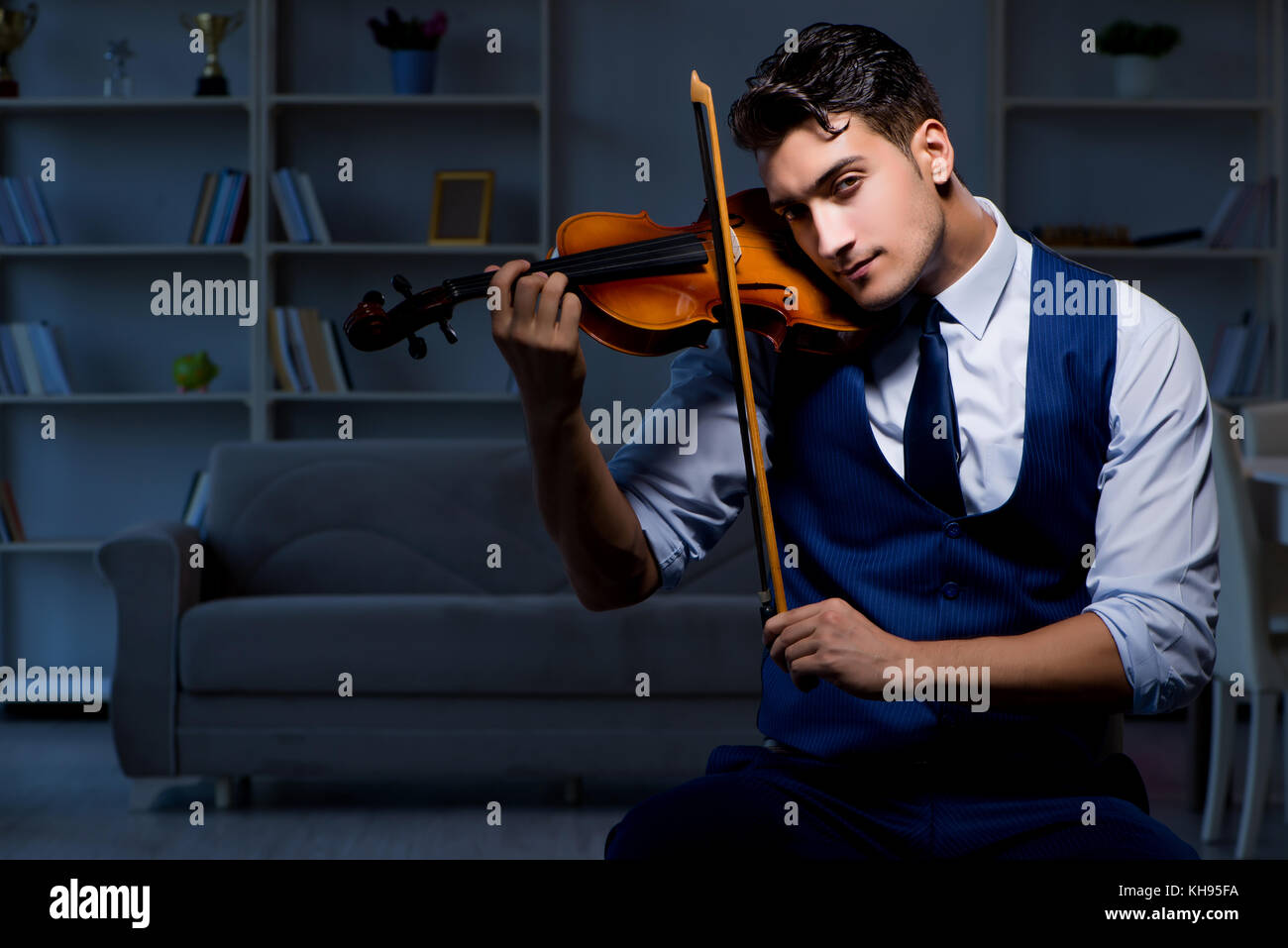 Young musician man practicing playing violin at home Stock Photo - Alamy